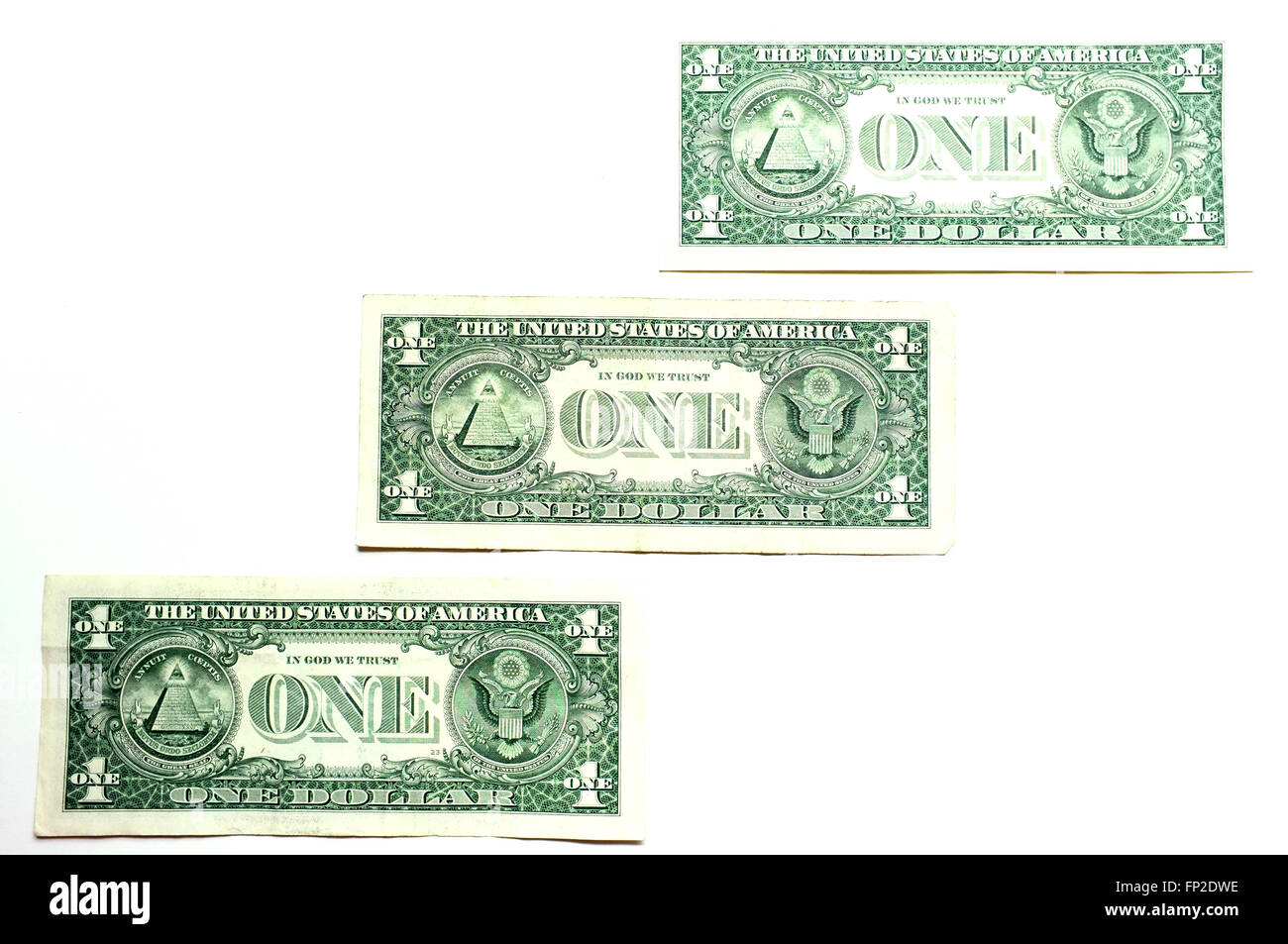 Three American One Dollar notes photographed against a white background ...