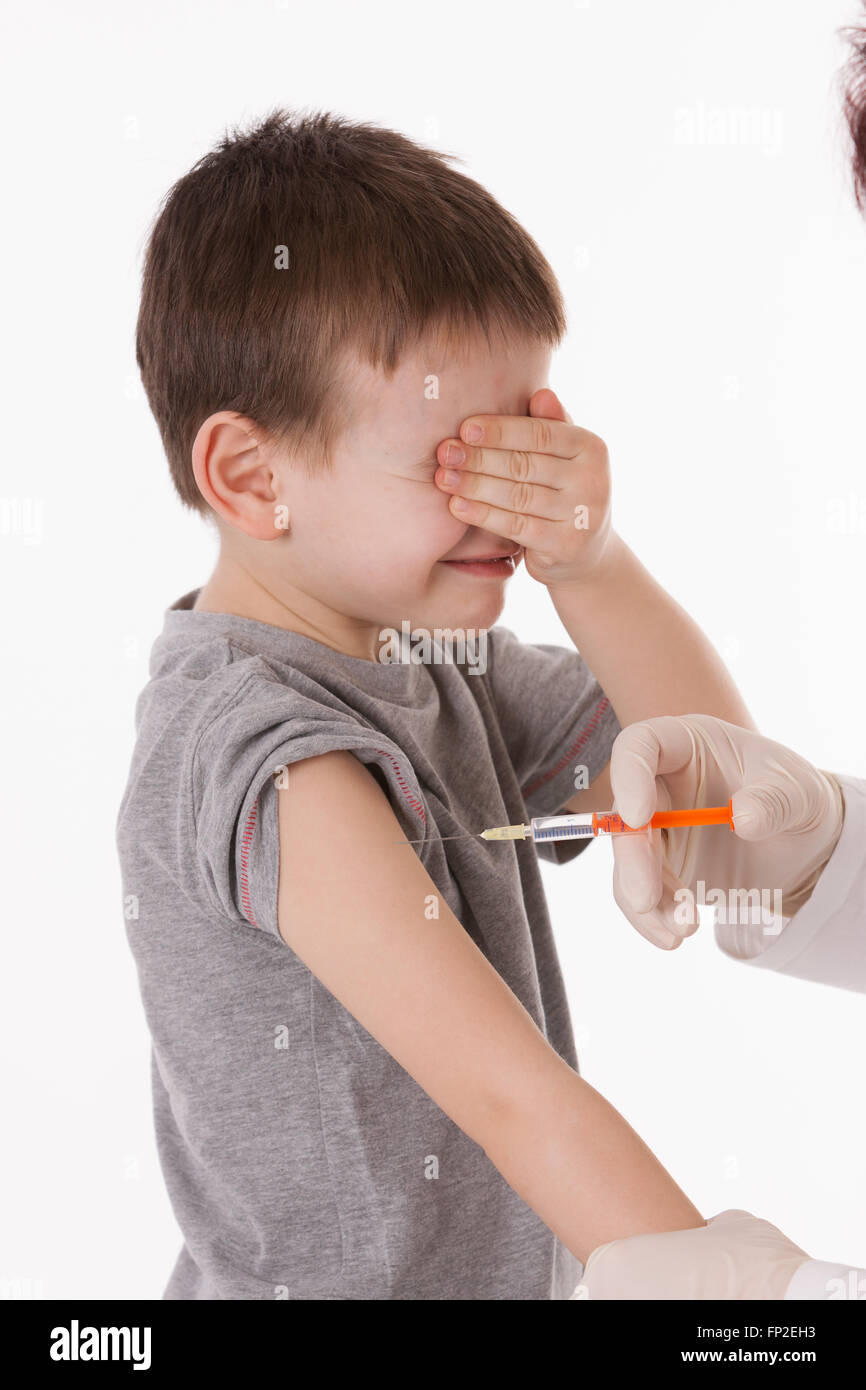 Doctor giving a child injection in arm on isolated image Stock Photo ...