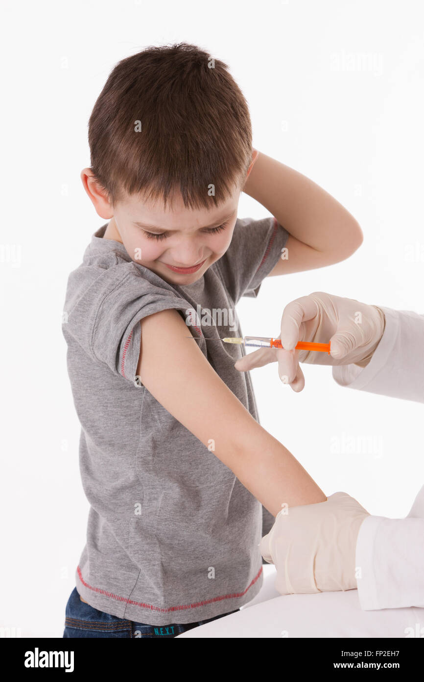 Doctor giving a child injection in arm on isolated image Stock Photo ...
