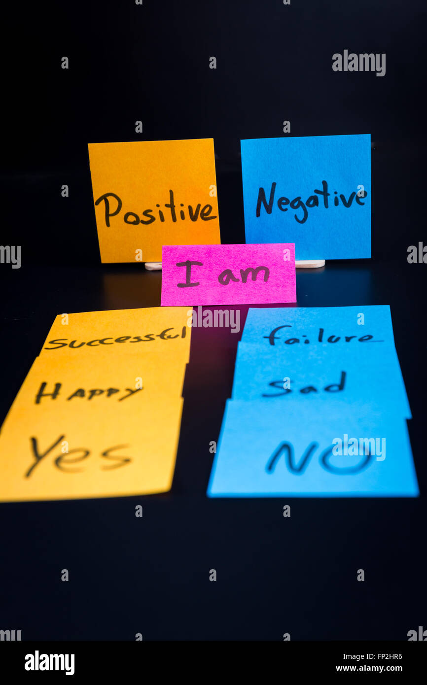 concept of duality using sticky notes with antonyms on a dark ...