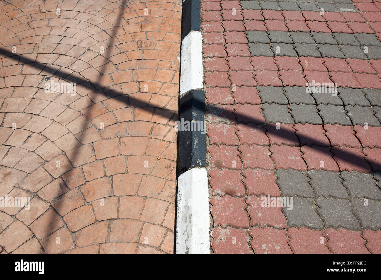 Abstract patterns created by road , tiles, path ways and shadows on a ...