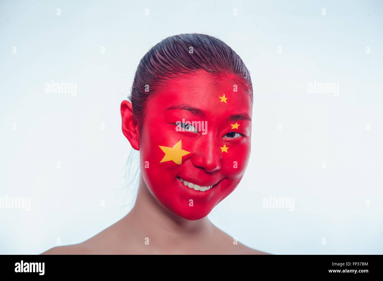 Girl with a Chinese flag on the face Stock Photo - Alamy