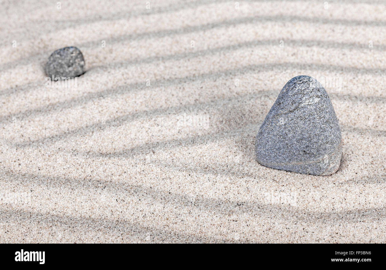 Two stones in sand, nature and harmony concept Stock Photo - Alamy