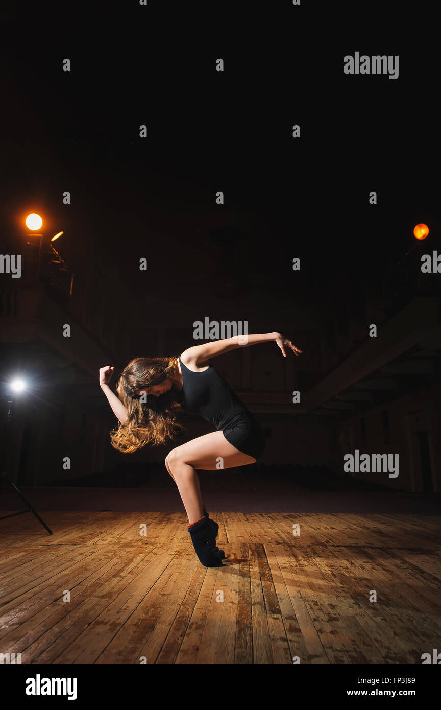 Young brunette dancer girl on stage Stock Photo - Alamy