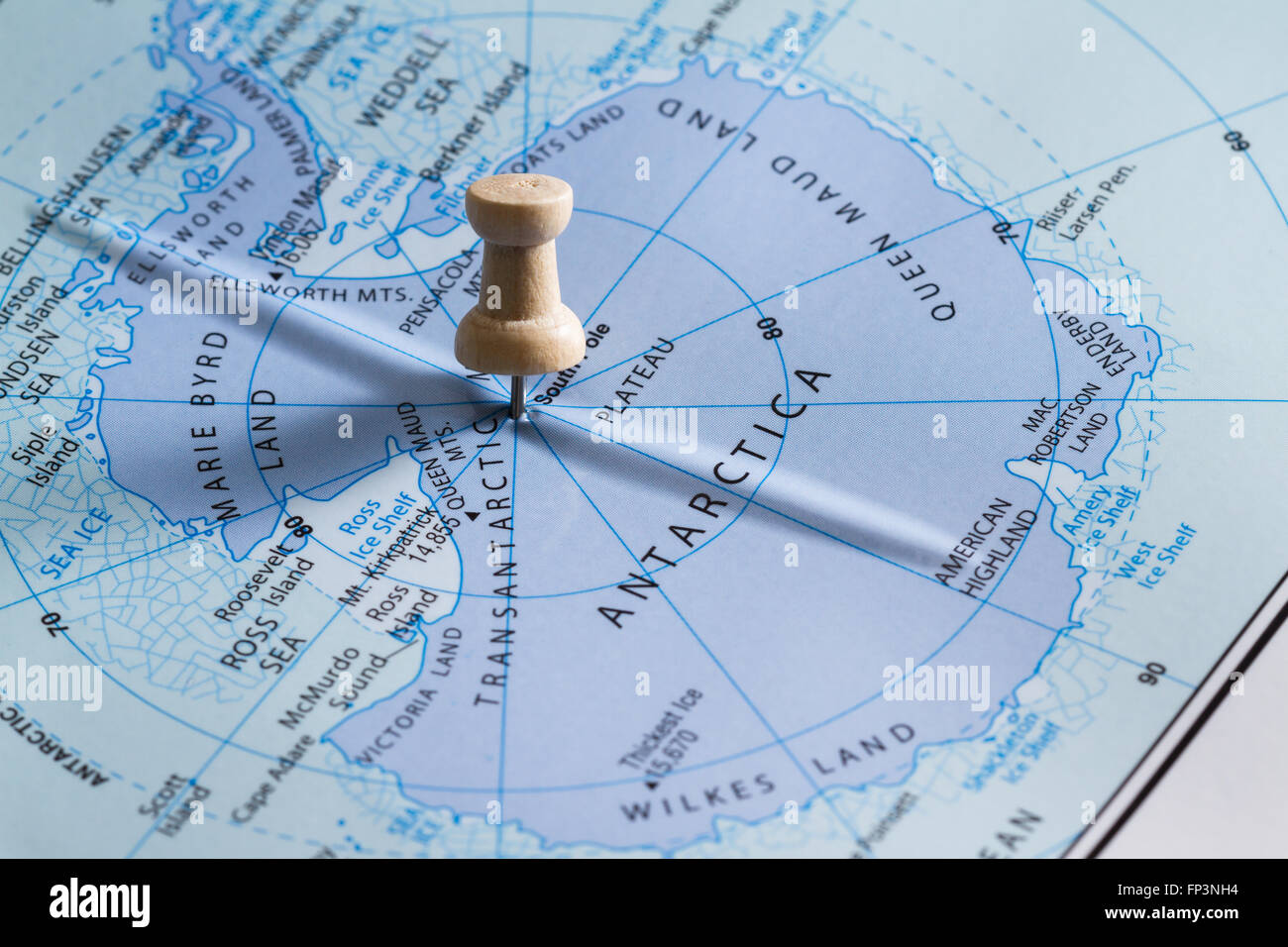 close up of map with the word Antarctica in focus with a push pin ...