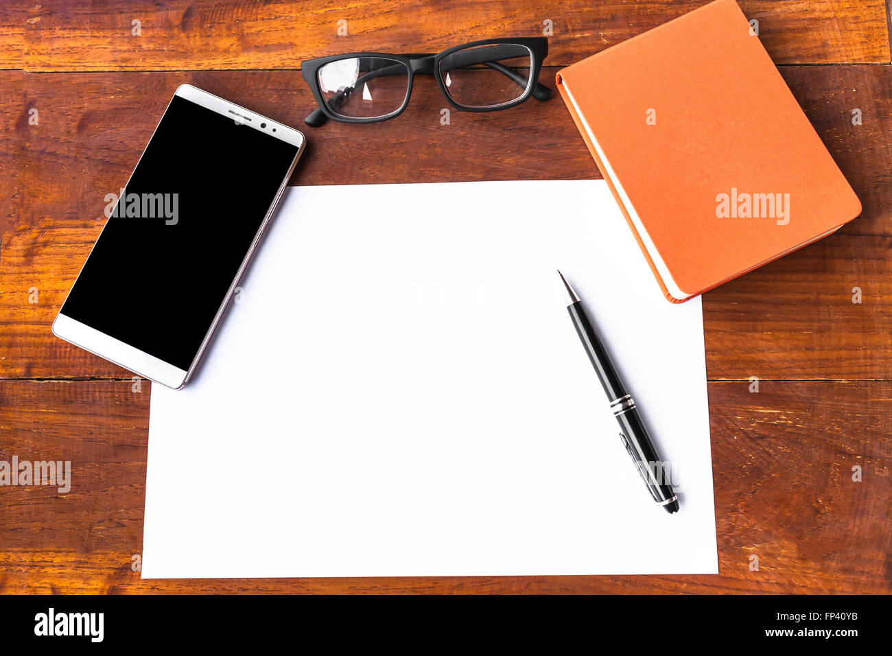 Blank paper with pen and smartphone on wood table concept and Idea for ...