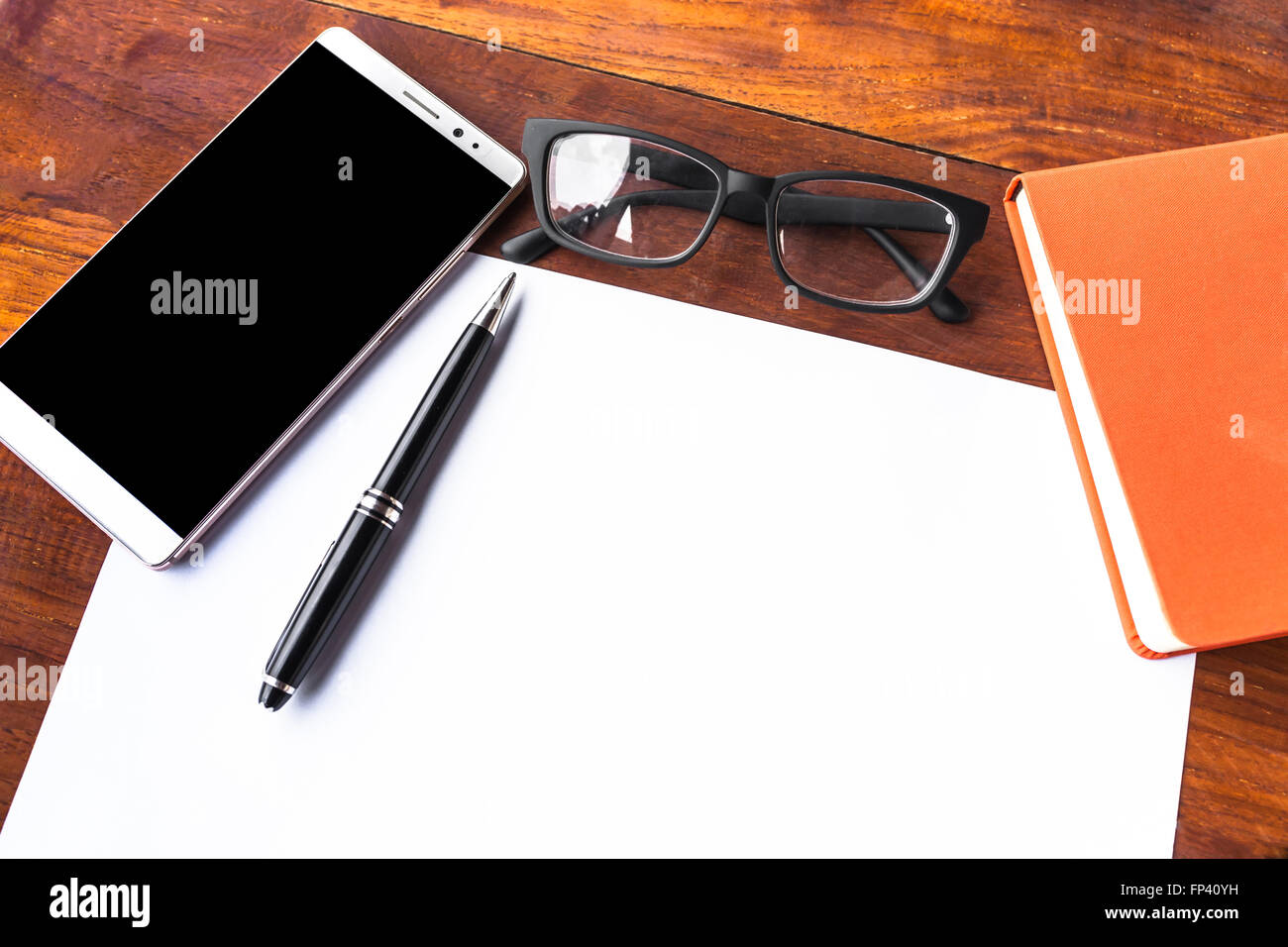 Blank paper with pen and smartphone on wood table concept and Idea for ...