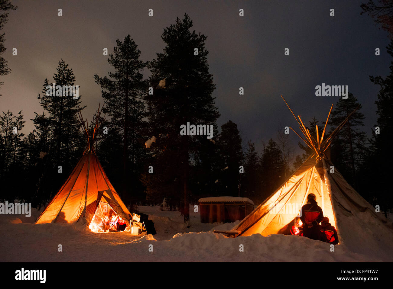 Tents for relax, drink and eat ather a snowmobiles race tour at night ...