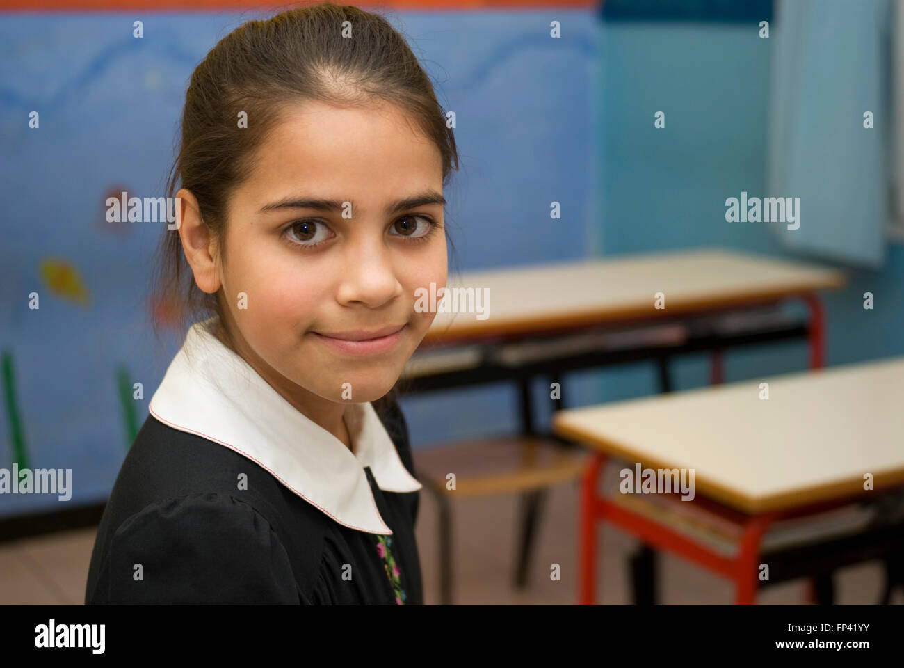 Elementary school student posing in uniform in a class setting Stock ...