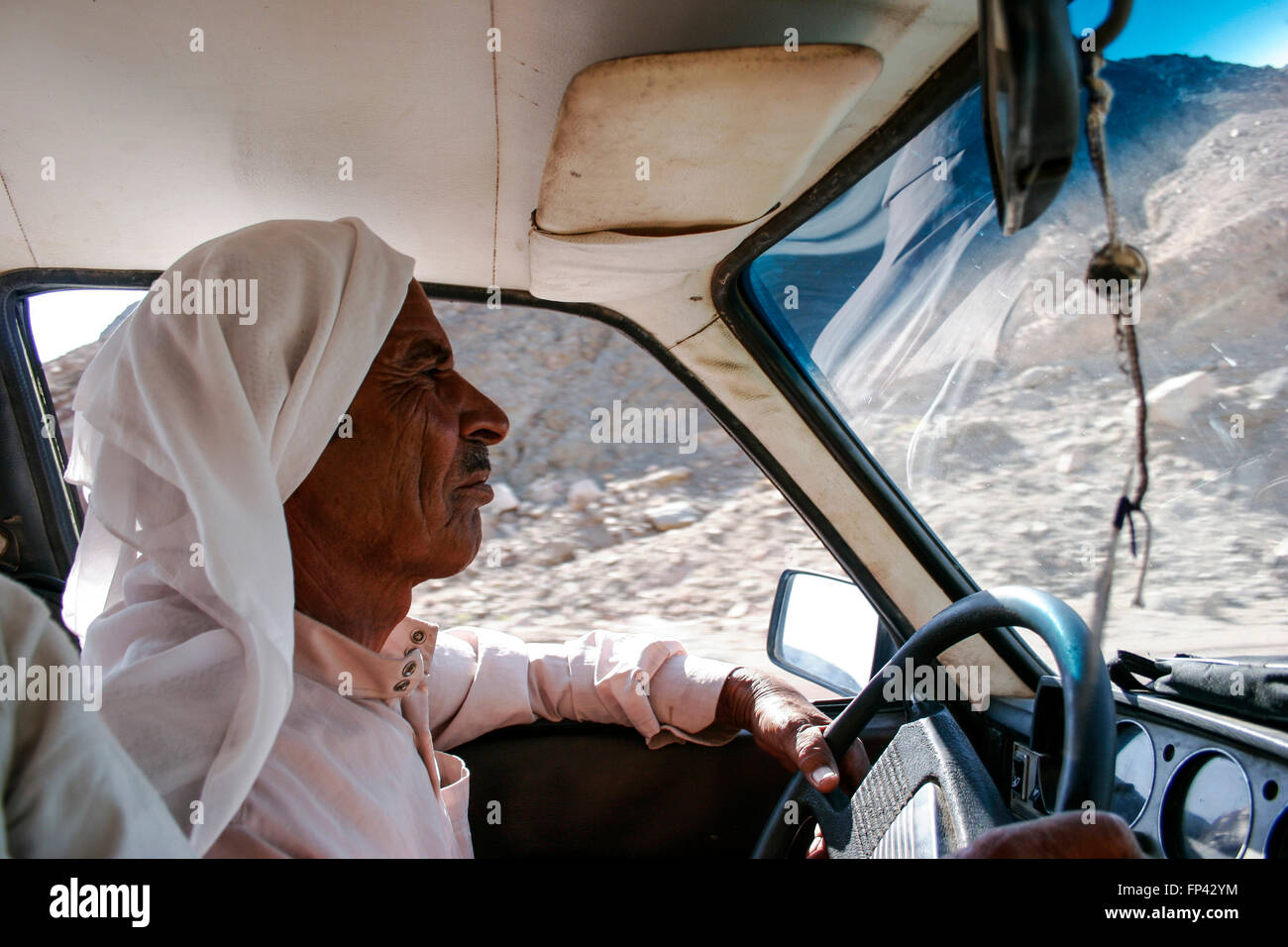 PORTRAIT OF AN EGYPTIAN TAXI DRIVER WEARING TRADITIONAL CLOTHES WHILE ...