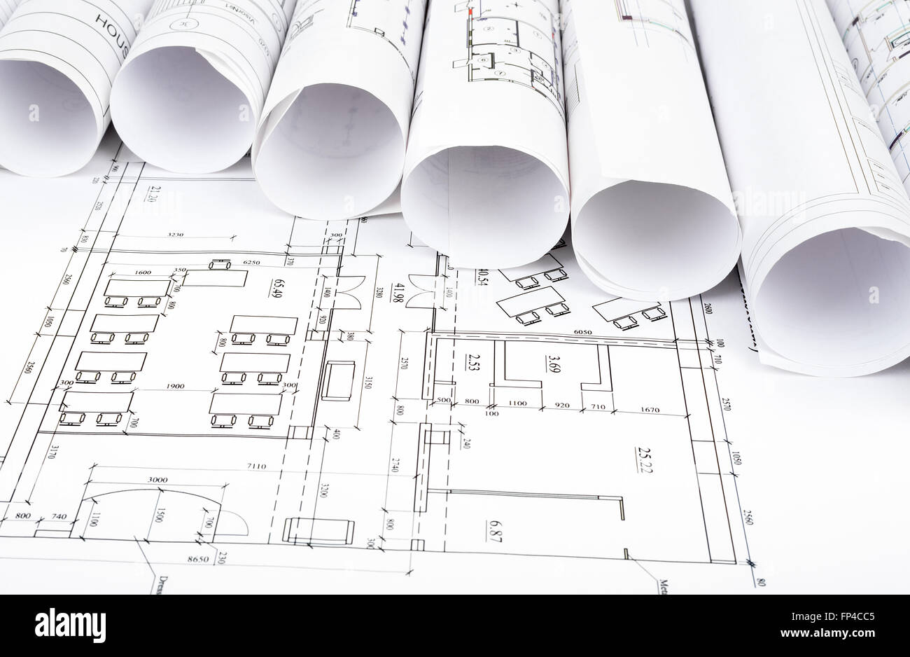 Blueprints and rolls of blueprints, close up view. Building concept ...