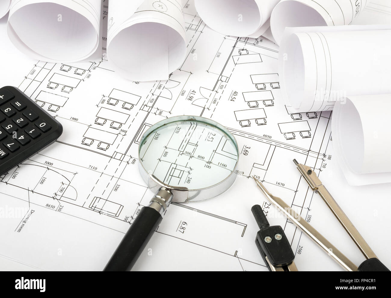 Rolls of blueprints with dividers and magnifier. Building concept Stock ...