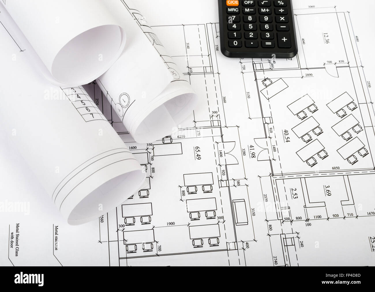 Architecture plan and rolls of blueprints with calculator. Building ...