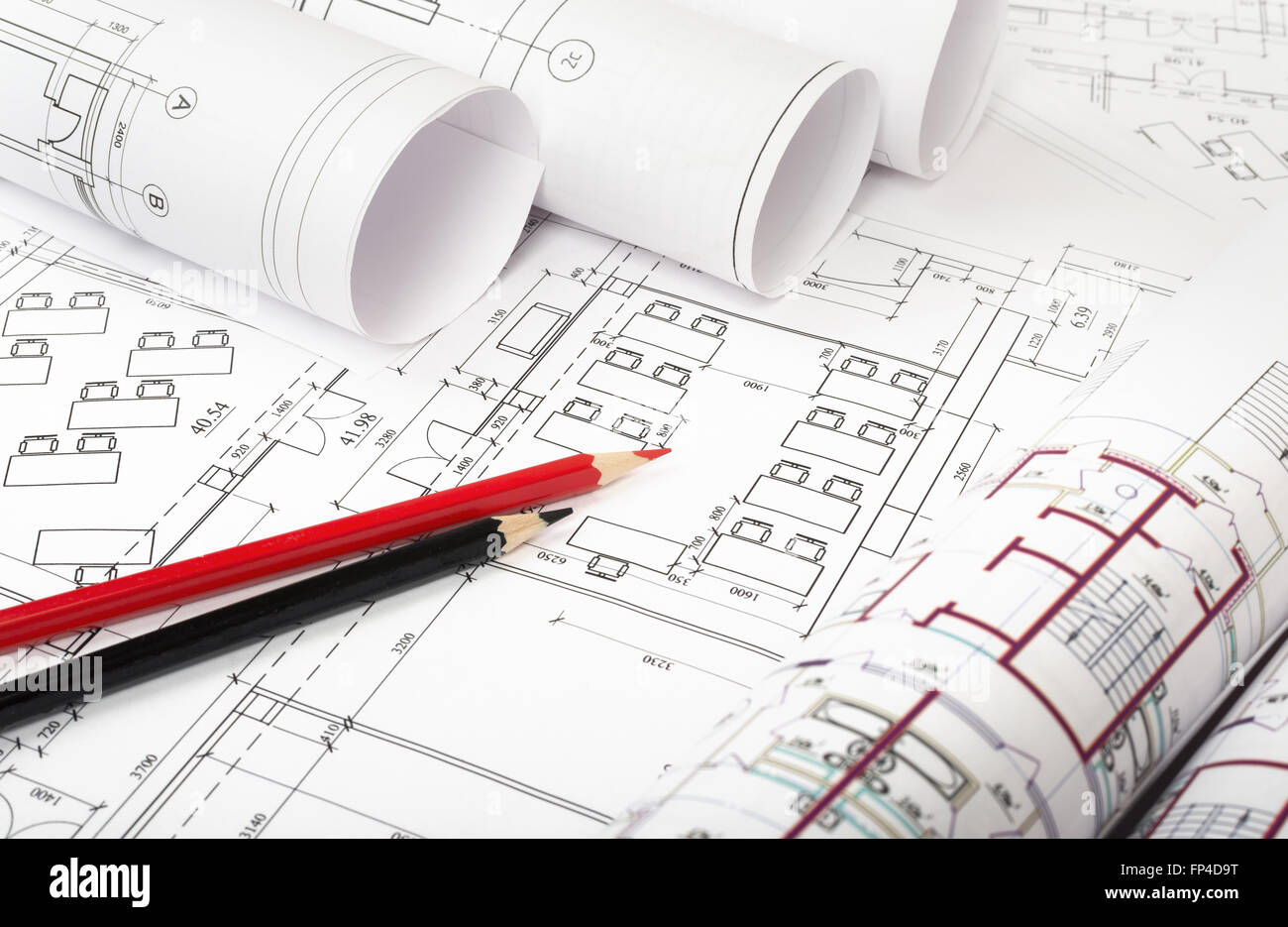 Architecture plan and rolls of blueprints with crayons. Building ...