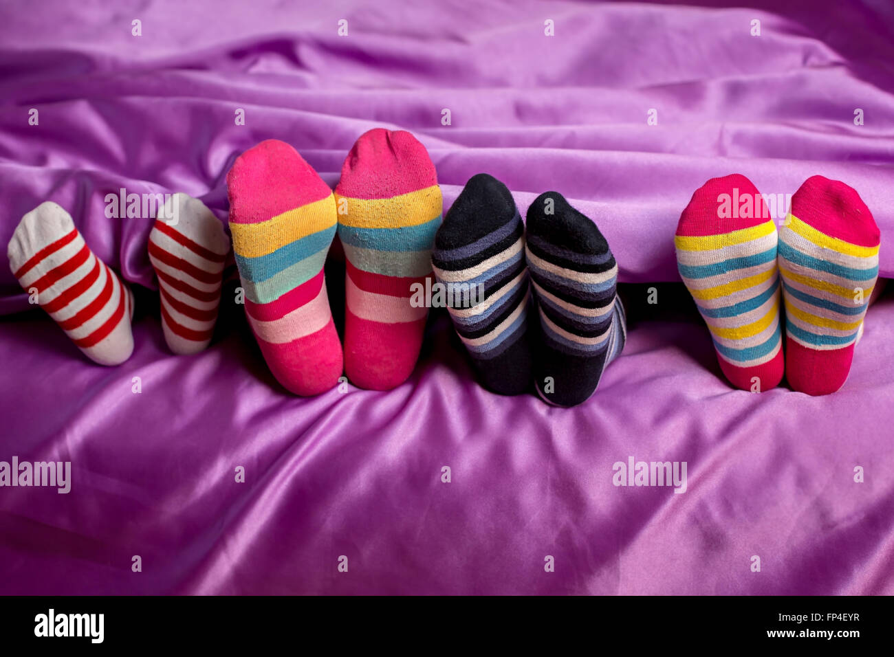 Small feet in colorful socks. Children's feet wearing colorful socks ...
