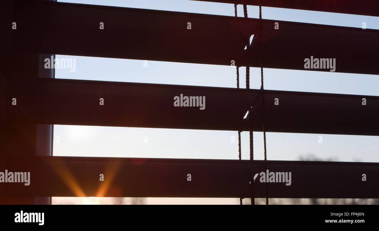 Sunrise morning window blinds Stock Photo - Alamy
