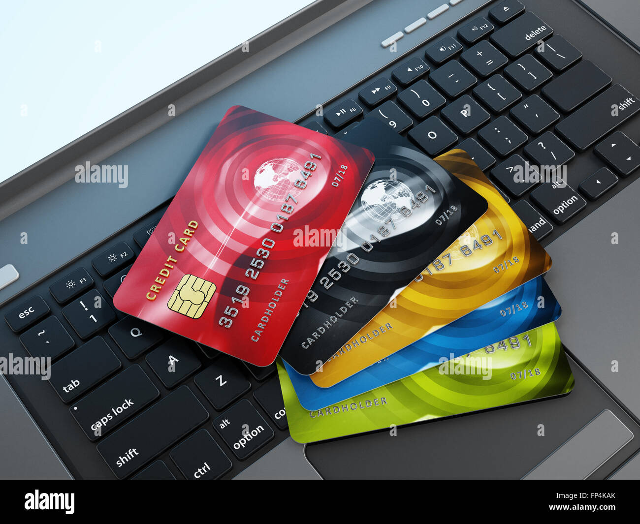Multi colored credit card standing on laptop keyboard Stock Photo - Alamy