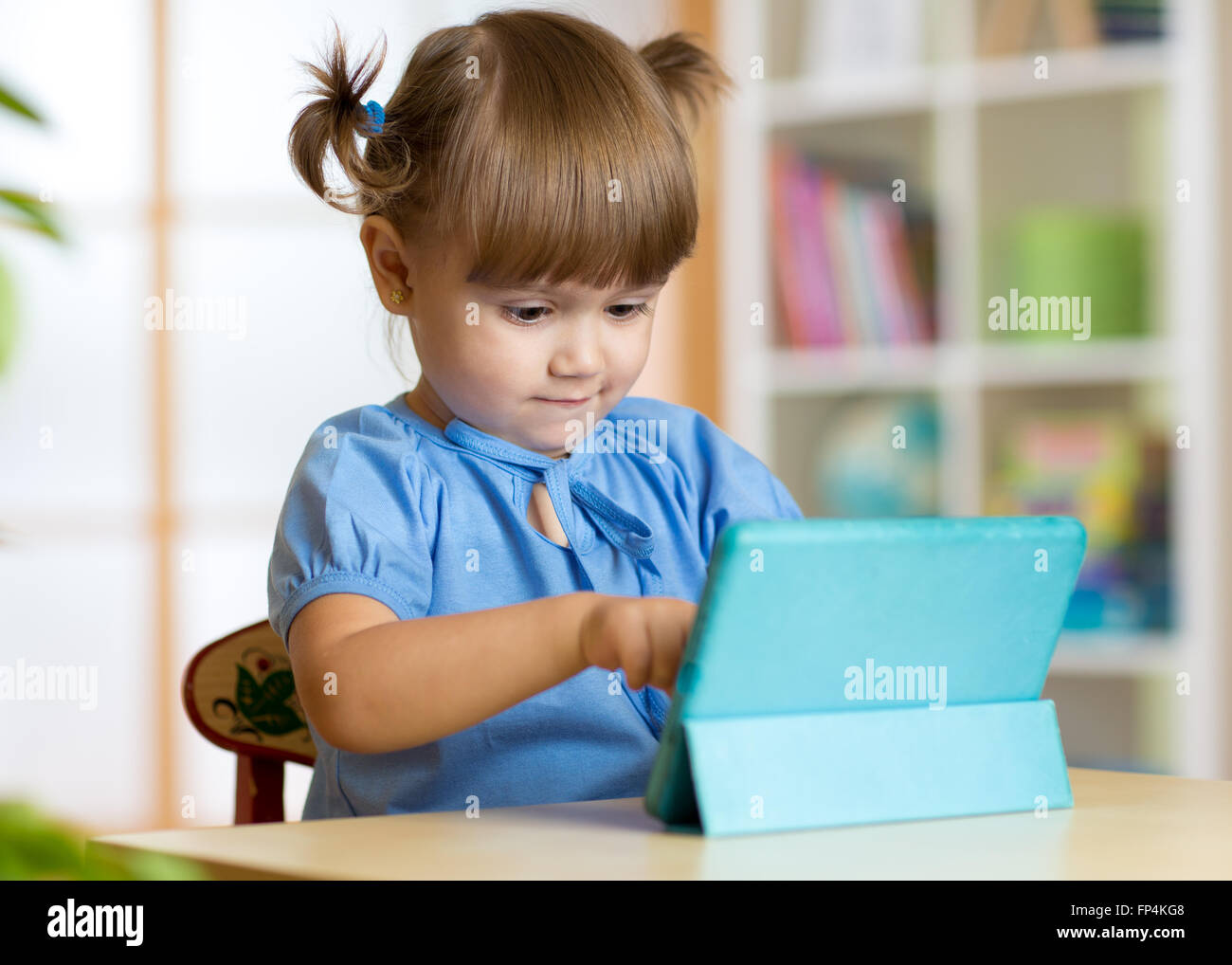 cute smiling little girl with the tablet PC Stock Photo - Alamy