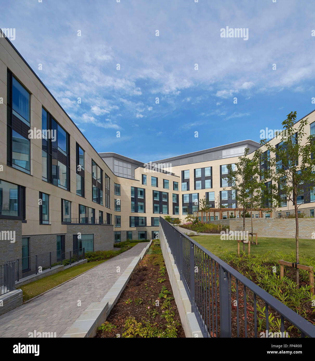 Landscaped park and garden area next to facade with walkway. Southmead ...