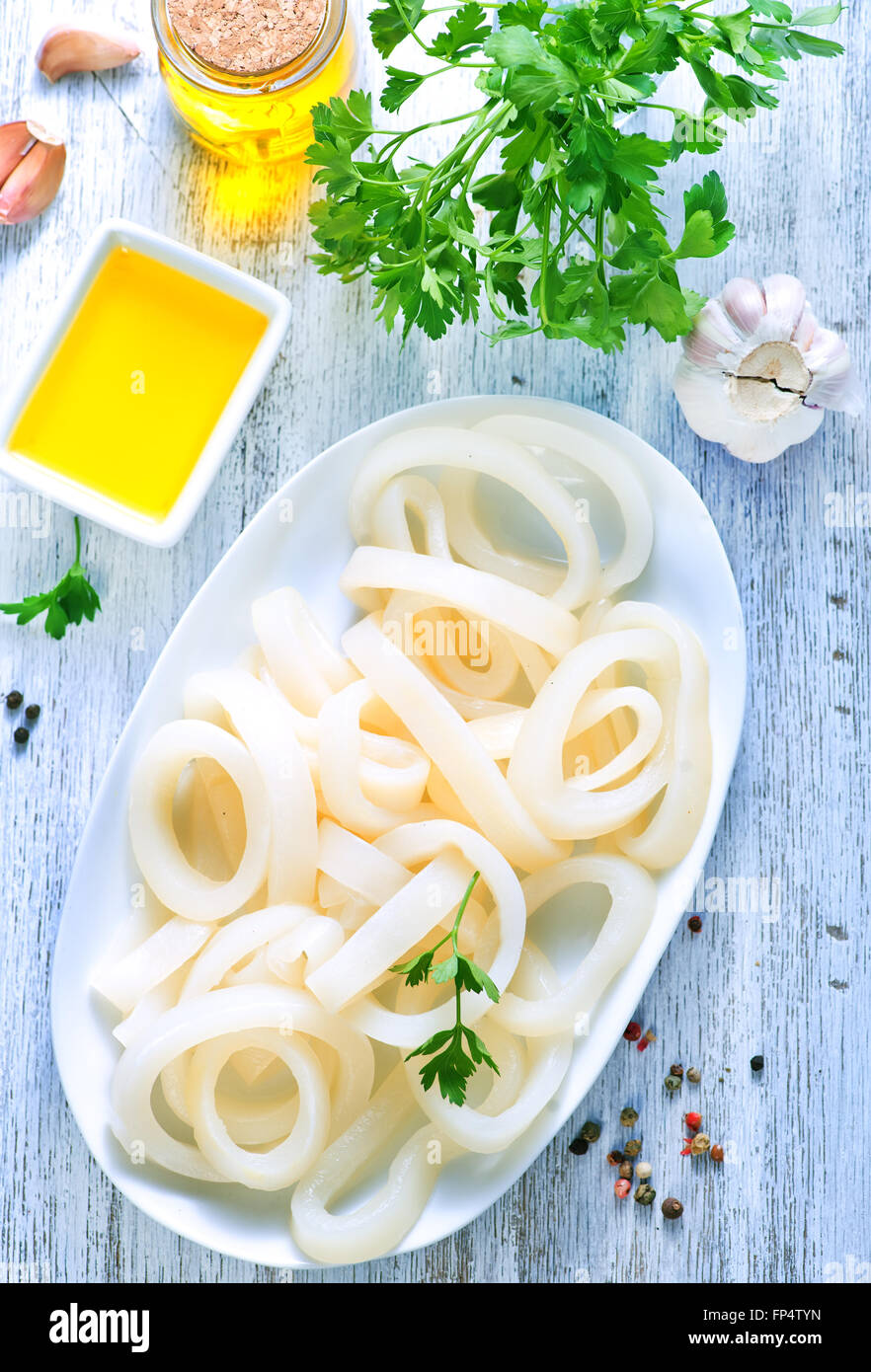 Raw squid rings with pepper on the plate Stock Photo - Alamy
