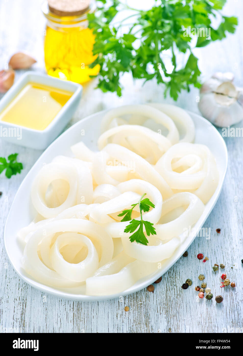 Raw squid rings with pepper on the plate Stock Photo - Alamy