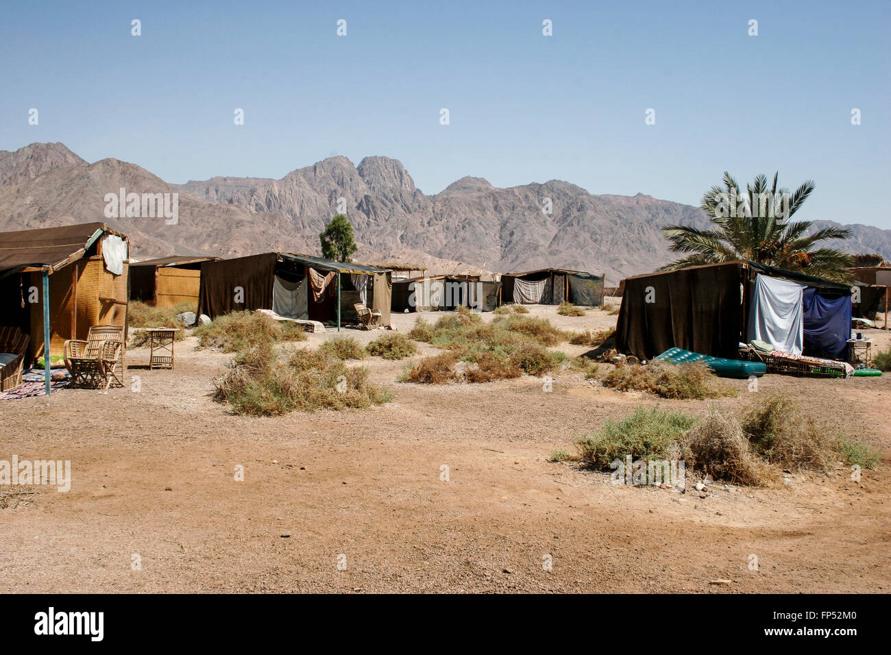 COMPOUND OF HUTS MADE FROM CANES AND SCRAP WOODS AT A DESERT AND DRY ...