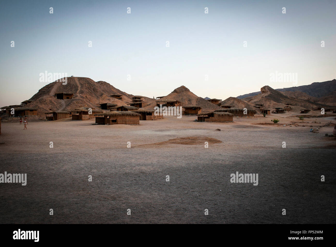 COMPOUND OF HUTS MADE FROM CANES AT A DESERT AND DRY LANDSCAPE SHOOT ...