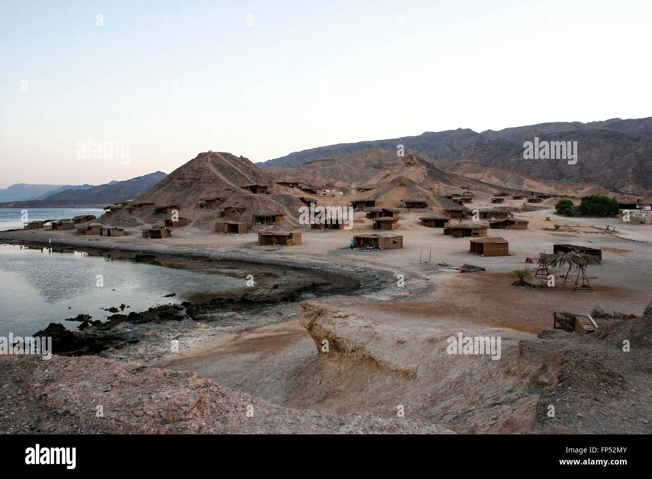 COMPOUND OF HUTS MADE FROM CANES AT A DESERT AND DRY LANDSCAPE SHOOT ...