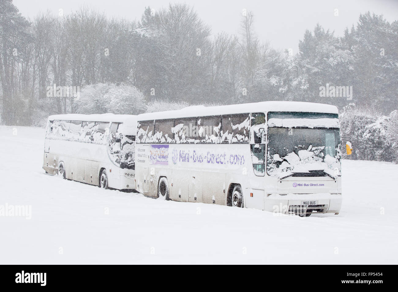 Two coaches parked up during a snow storm Stock Photo - Alamy