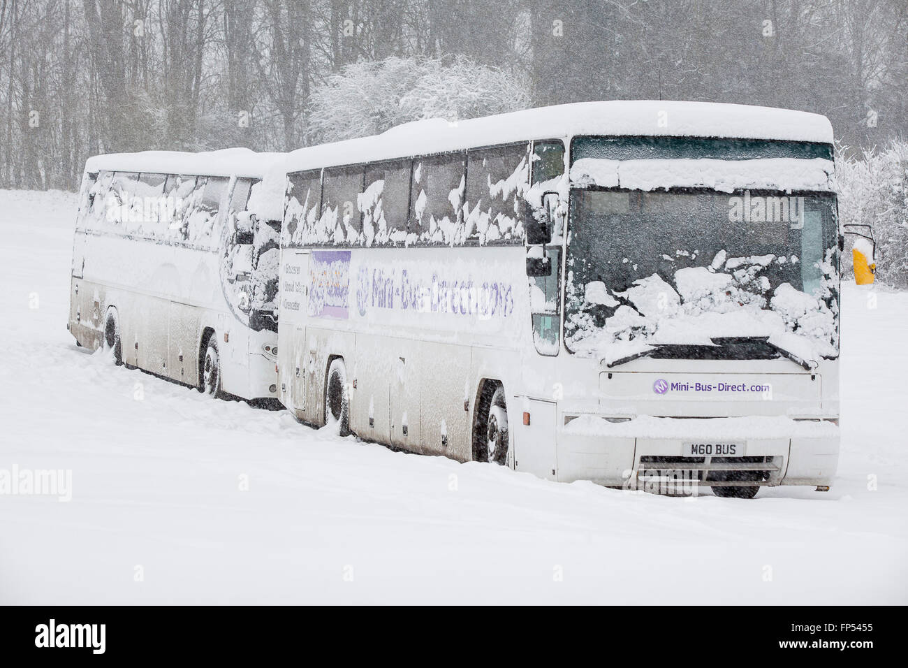 Two coaches parked up during a snow storm Stock Photo - Alamy