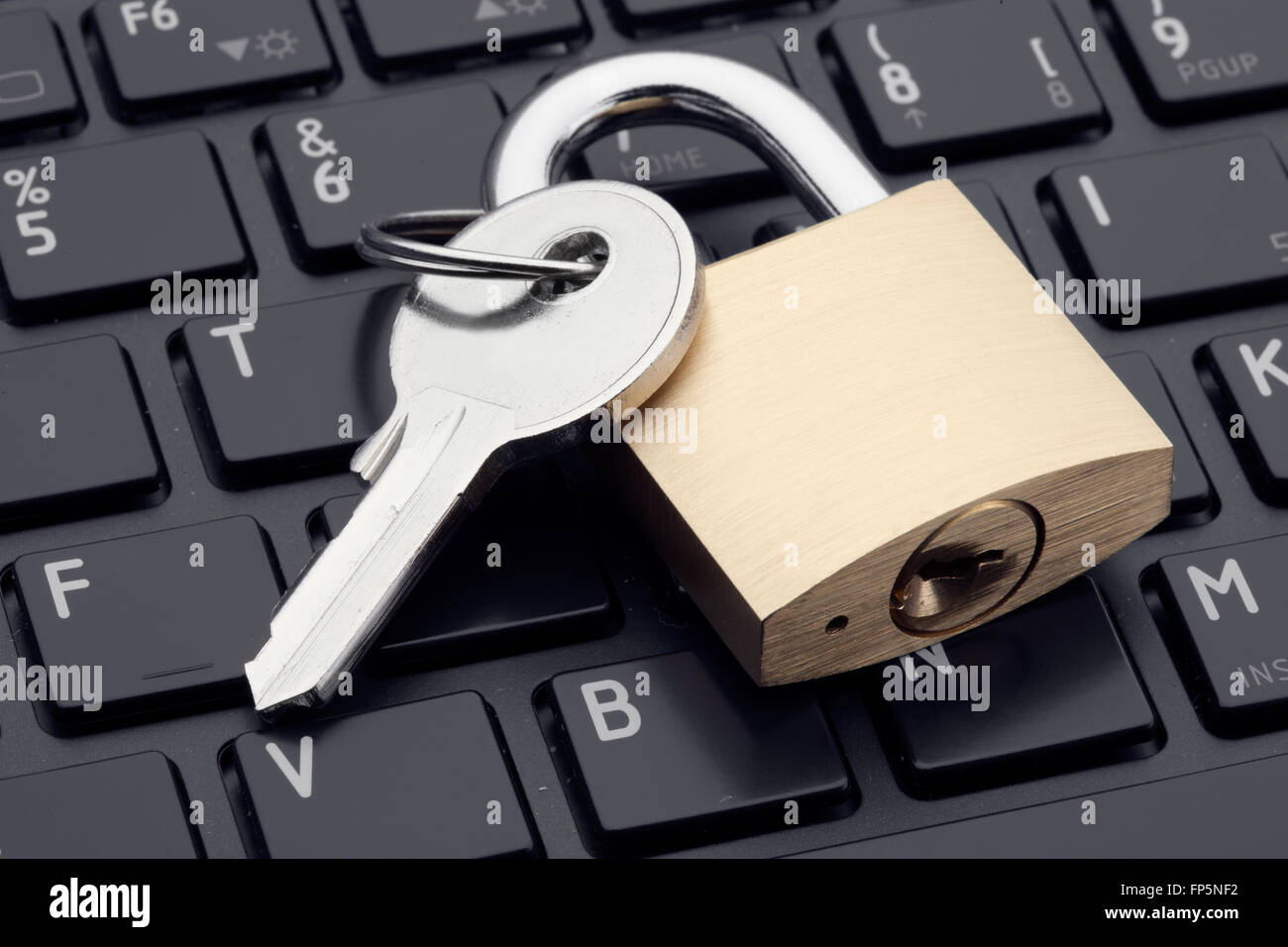 Computer security or safety concept. Laptop keyboard with lock and key ...