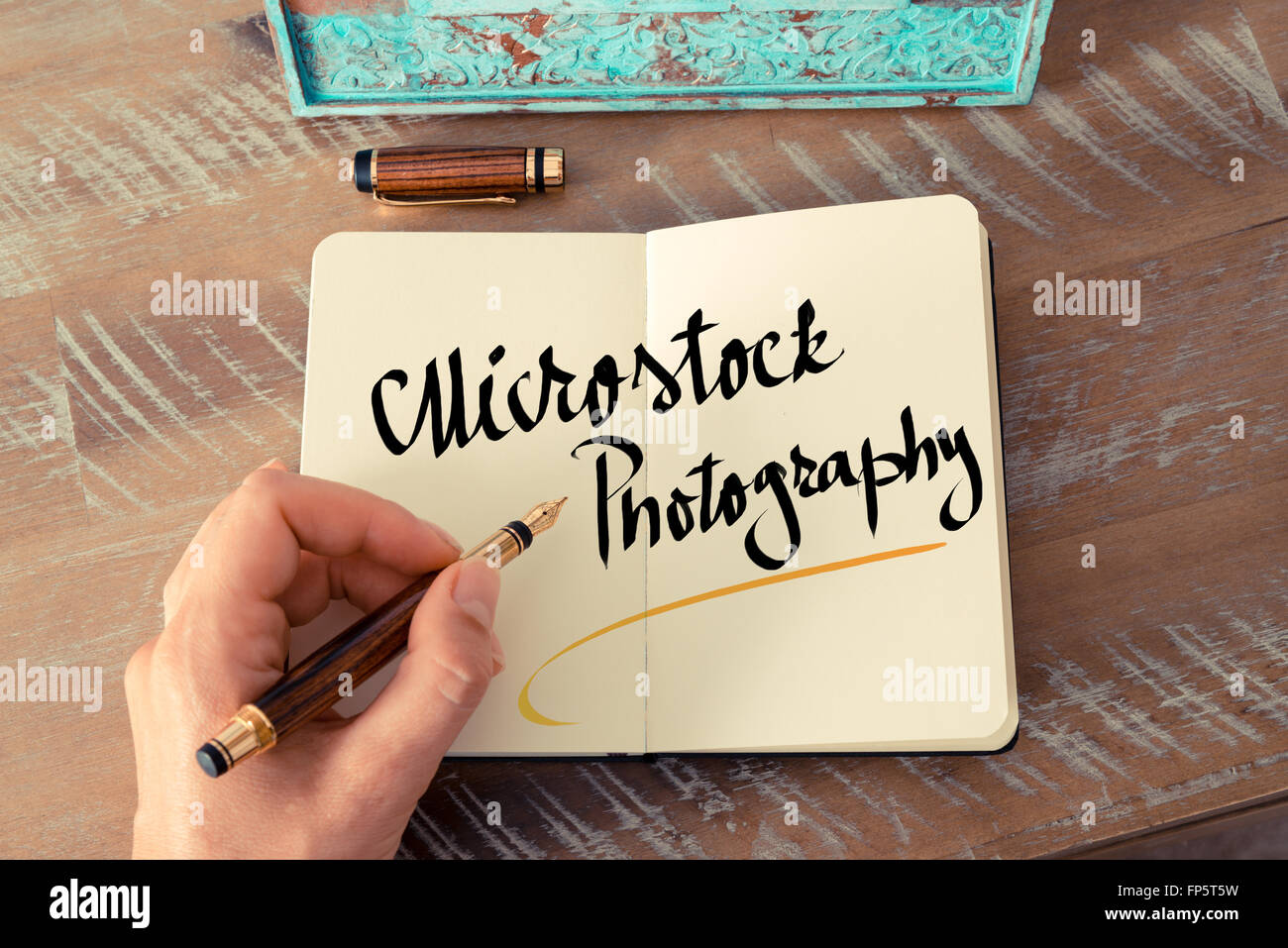 Retro effect and toned image of a woman hand writing a note with a ...