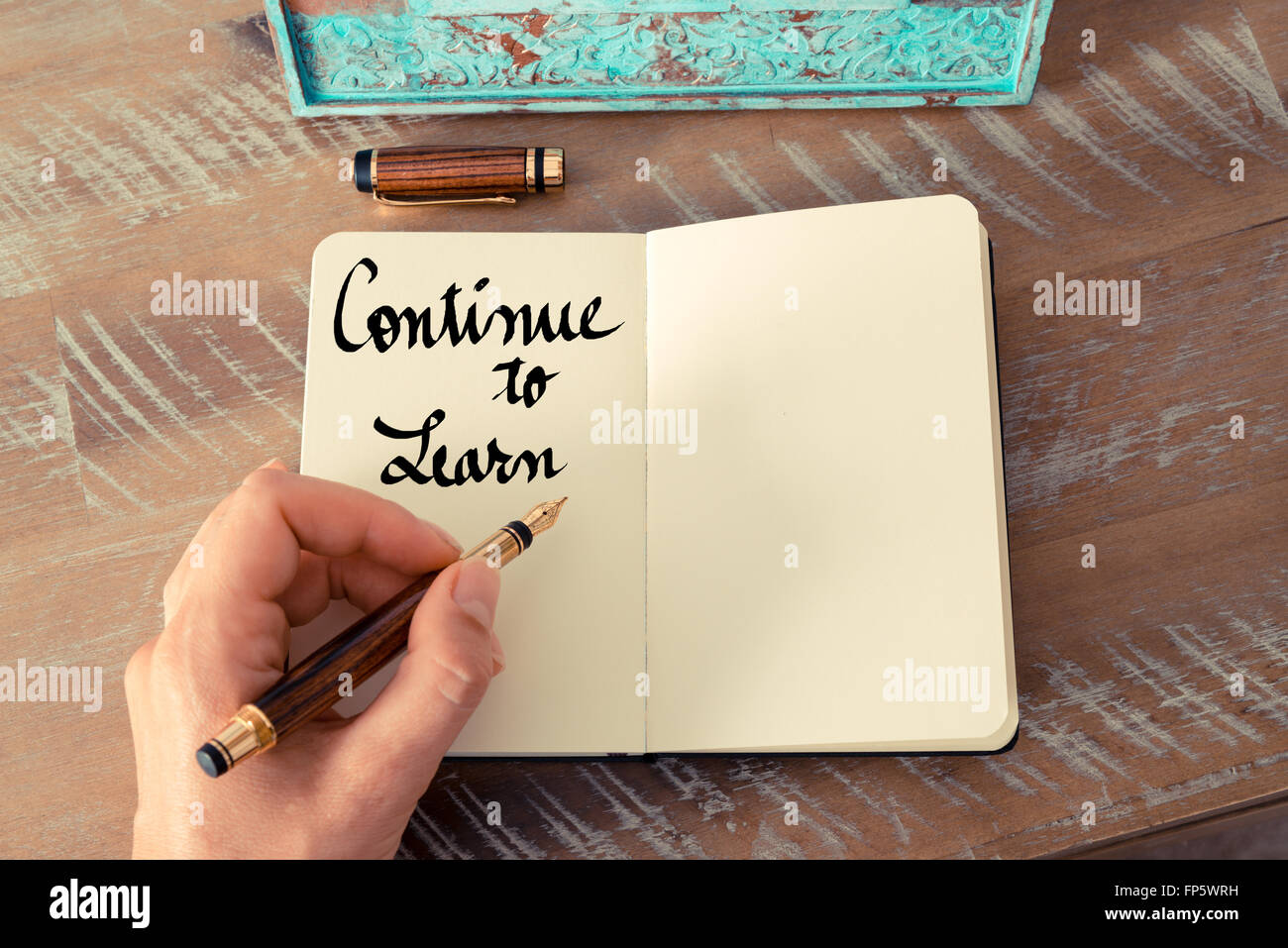 Retro effect and toned image of a woman hand writing a note with a ...