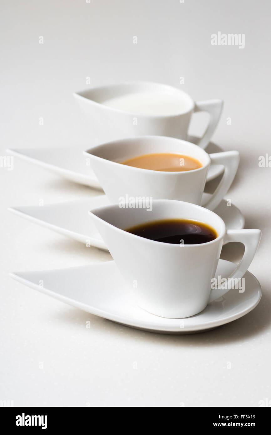 three white coffee cups on white stone table Stock Photo - Alamy