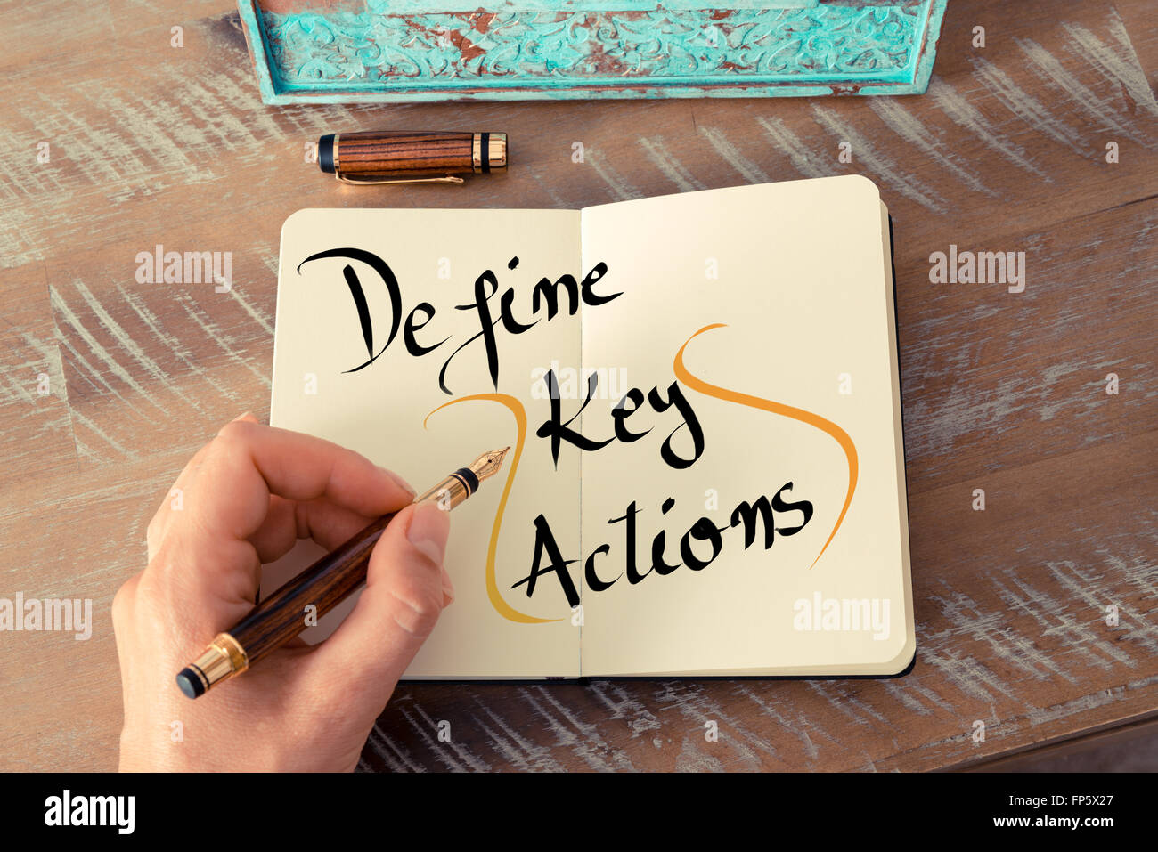 Retro effect and toned image of a woman hand writing a note with a ...
