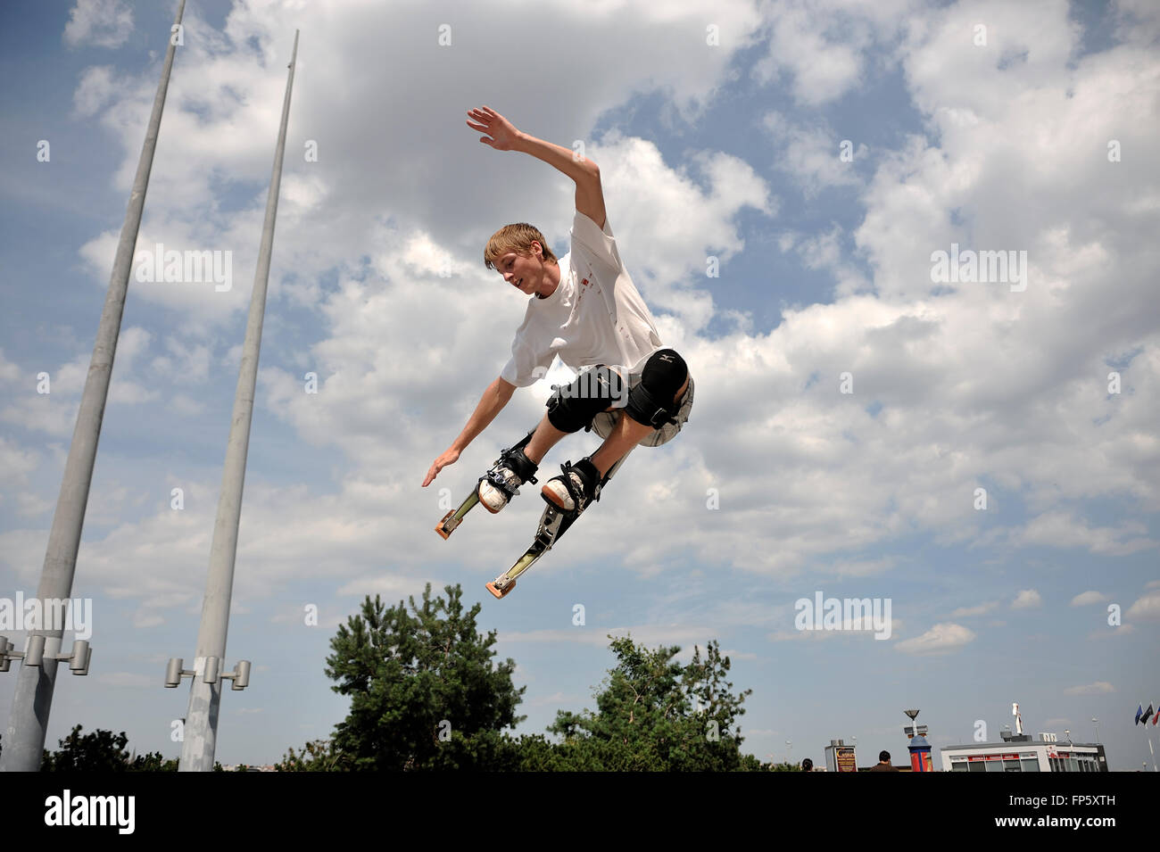 Young man on a jumping boots Stock Photo - Alamy