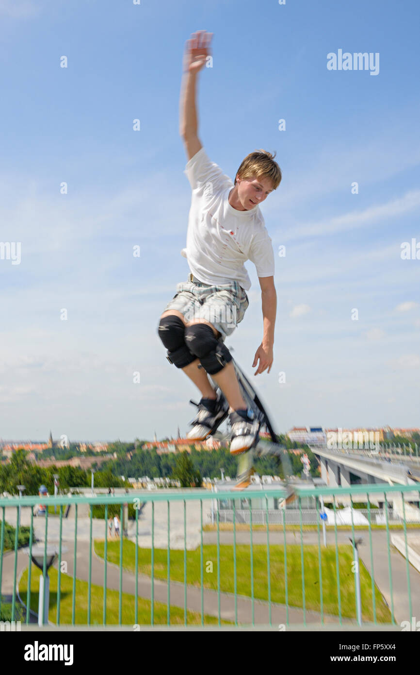 Young man on a jumping boots Stock Photo - Alamy
