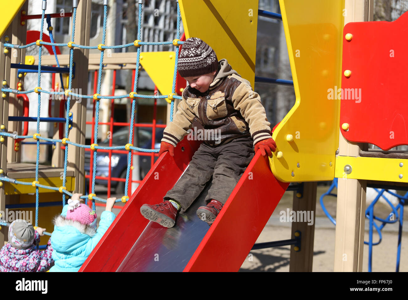 children play on the playground. early spring Stock Photo - Alamy