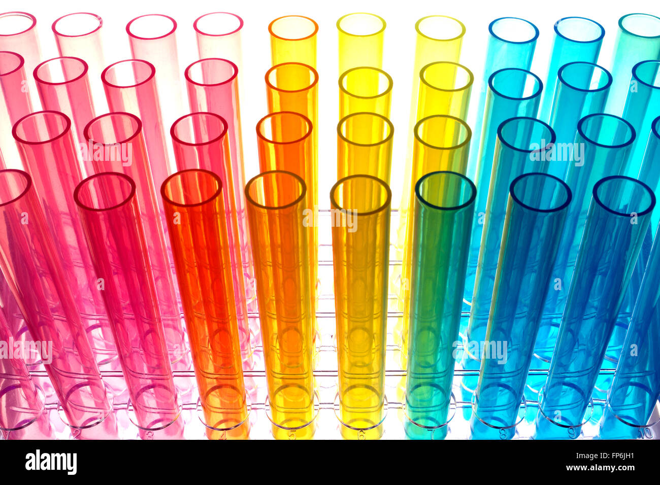 Plastic laboratory test tubes in rainbow colors on a rack in a science ...