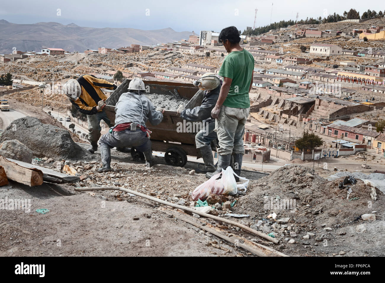 Miners emptying mine cart at Cerro Rico silver mine, Potosi. El Cerro ...