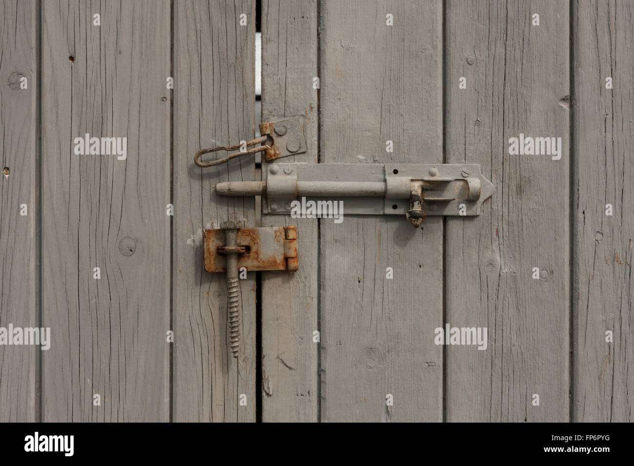 Rusty lock on a grey wooden door Stock Photo - Alamy