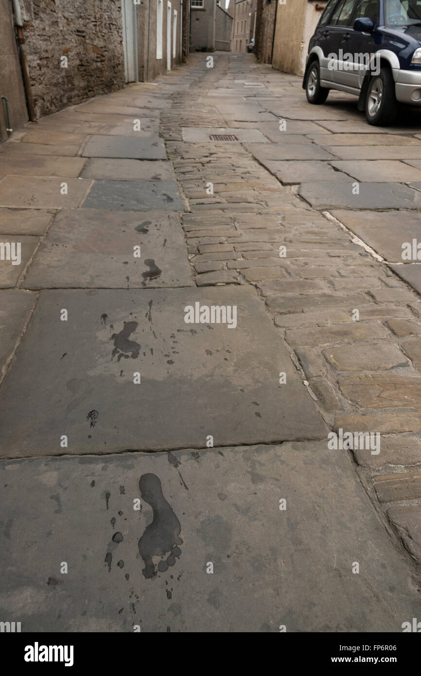 wet footprints on grey flagstones Stock Photo - Alamy