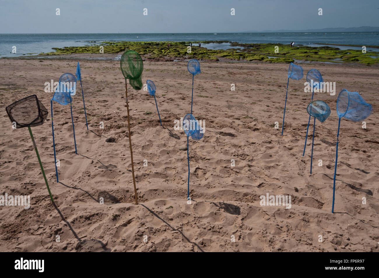 Childrens fishing nets on sandy beach Stock Photo - Alamy