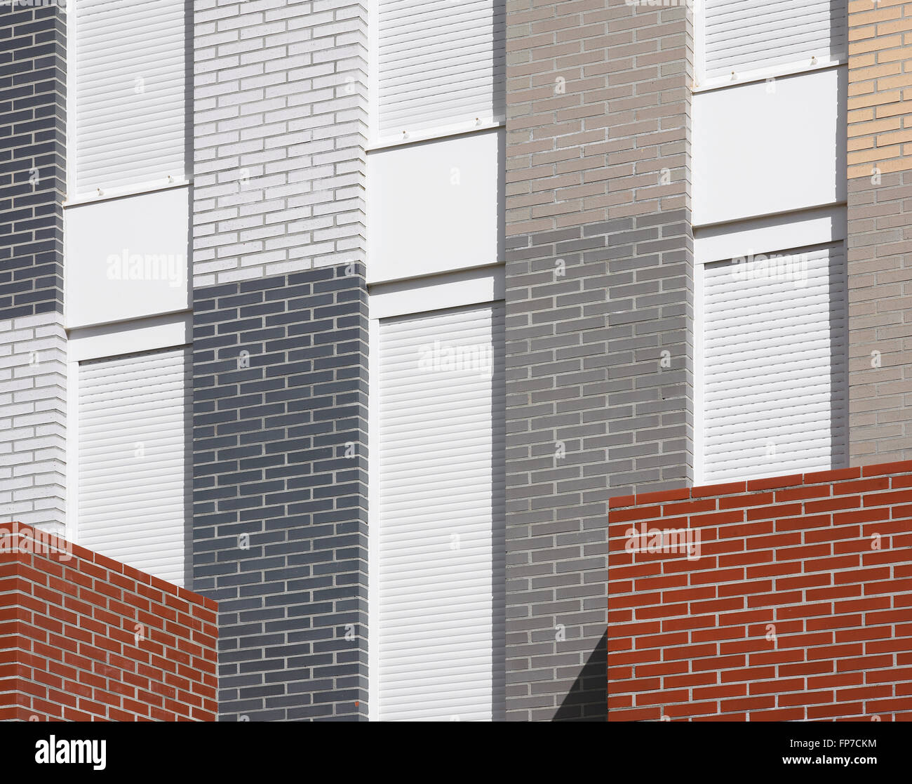 Modern building facade detail with multicolored bricks. Horizontal ...