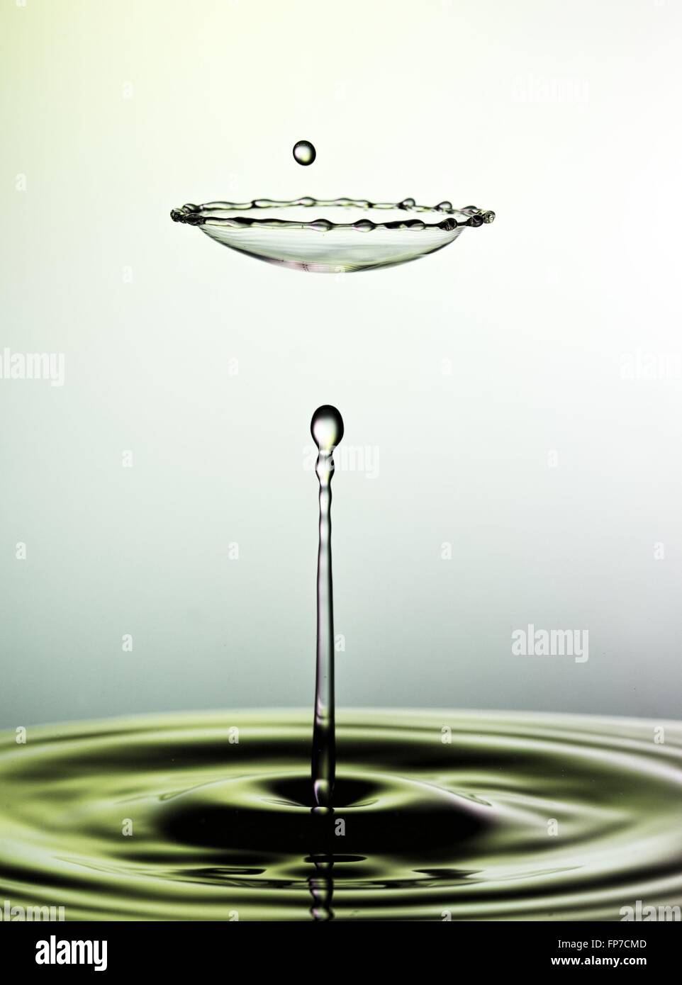 High speed flash water drop with floating 'cup'. One small water ...