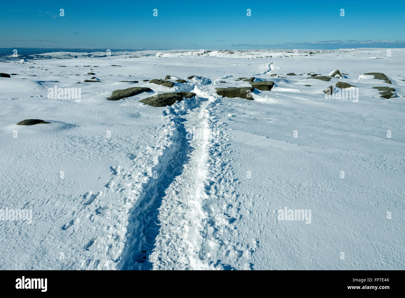 Trail in snow near Kinder Low summit, on the Kinder Scout plateau ...