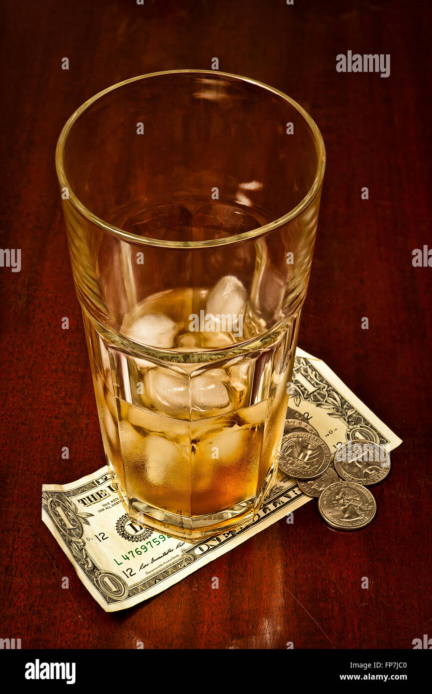 Drinking Glass With Tip Money Stock Photo - Alamy