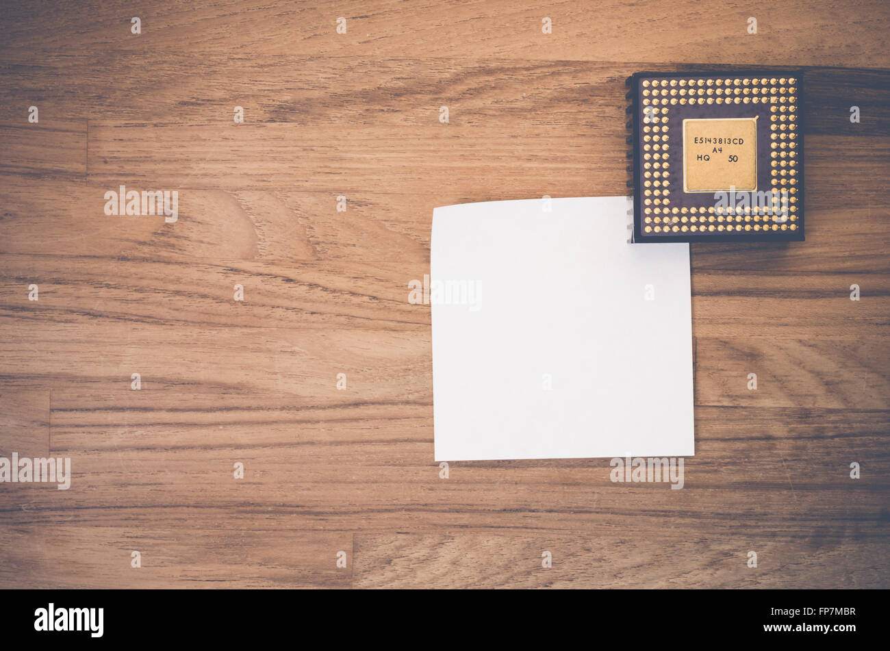 microprocessor package back side view an blank post it on a wood ...