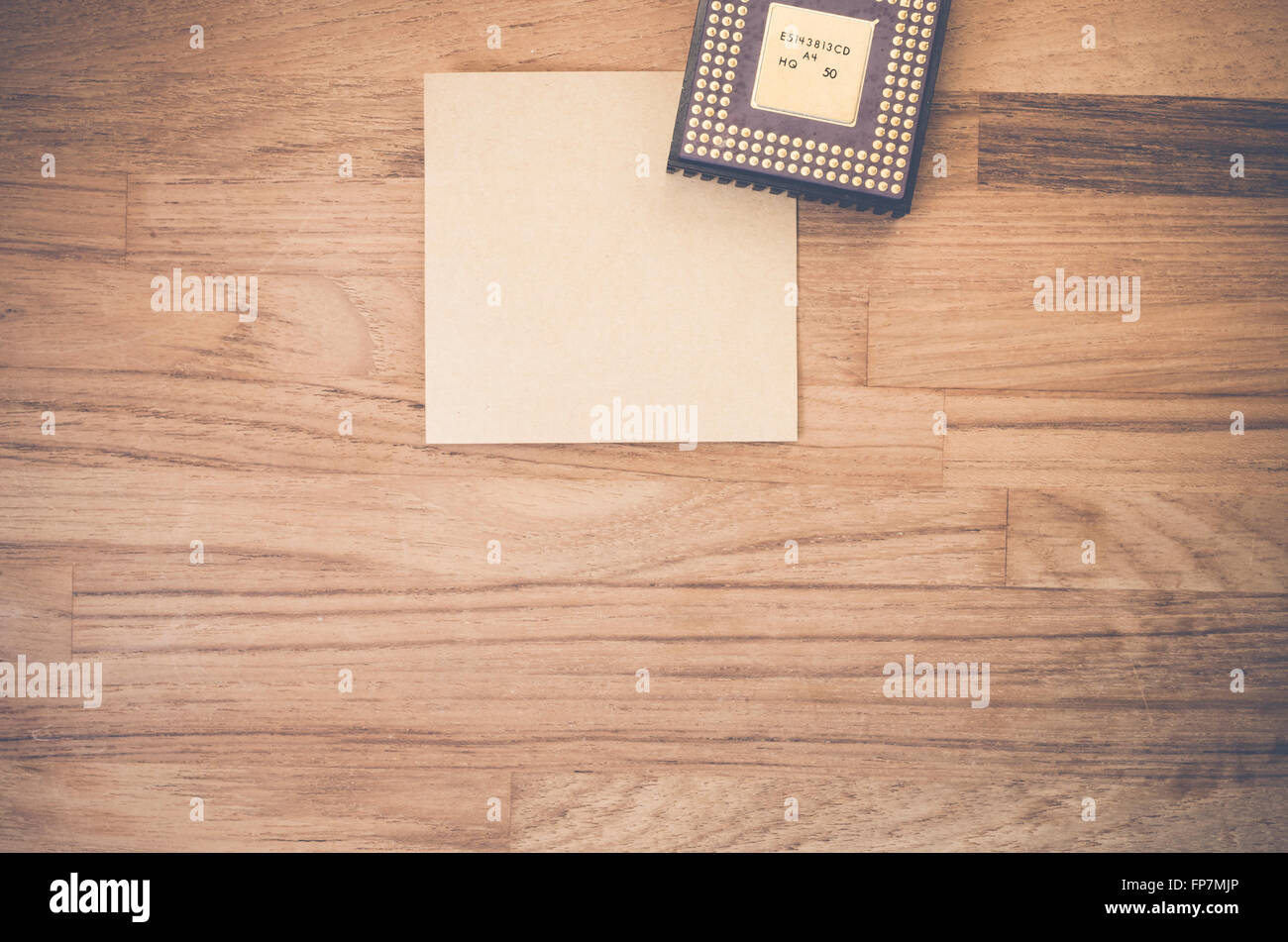 microprocessor package back side view an blank post it on a wood ...