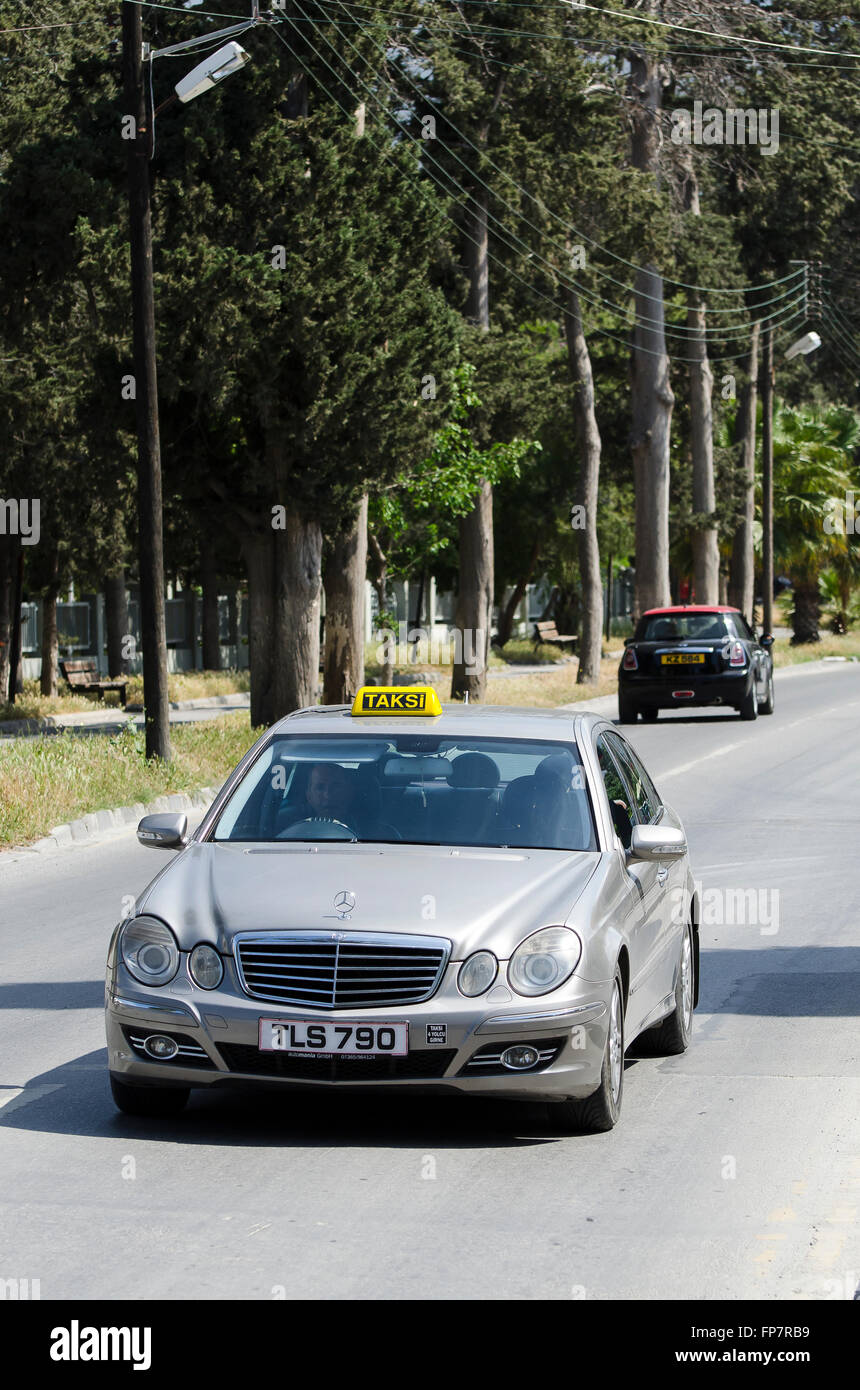 Mercedes taxi driving along a road in the city of Kyrenia, Northern ...